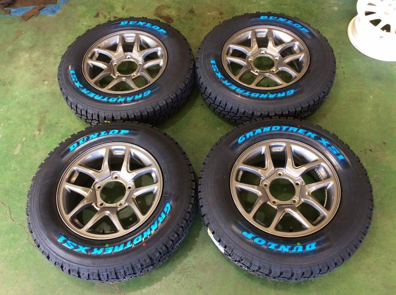 99 スズキ JB64 ジムニー純正アルミ + DUNLOP(ダンロップ) GRANDTREK XS1 185/85R16 ★タイヤは新品!ホワイトレターのスタッドレス!オールシーズン ...